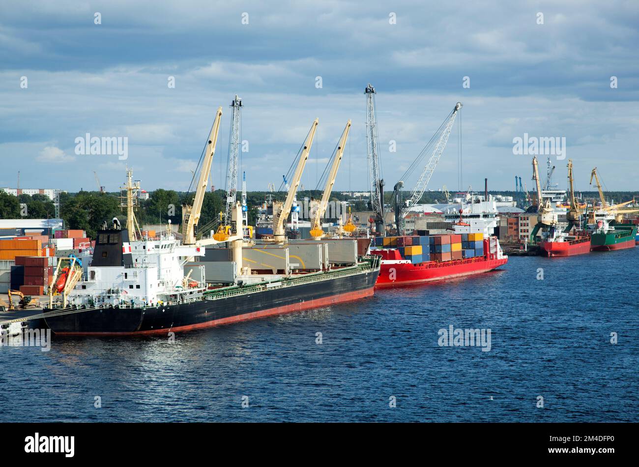 The row of cargo ships getting loaded in Riga city port (Latvia Stock ...