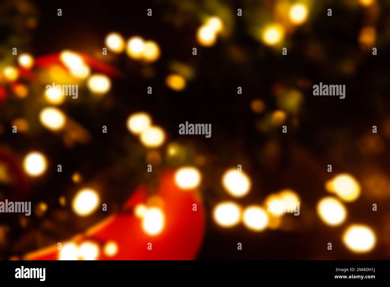 Bright, blurry lights on a Christmas tree from a garland. Festive ...