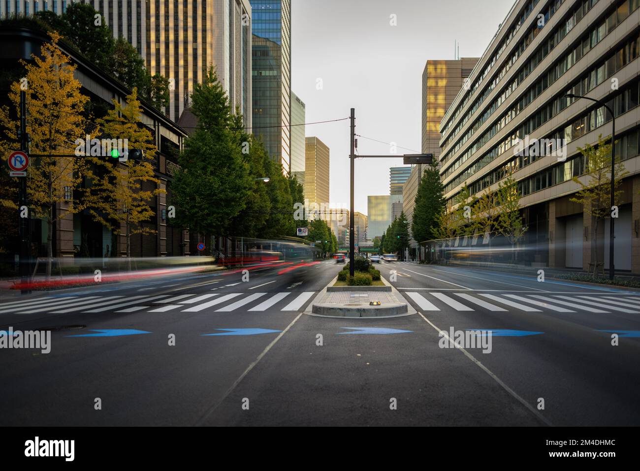 Cars blur through intersection by downtown offices at sunrise Stock ...