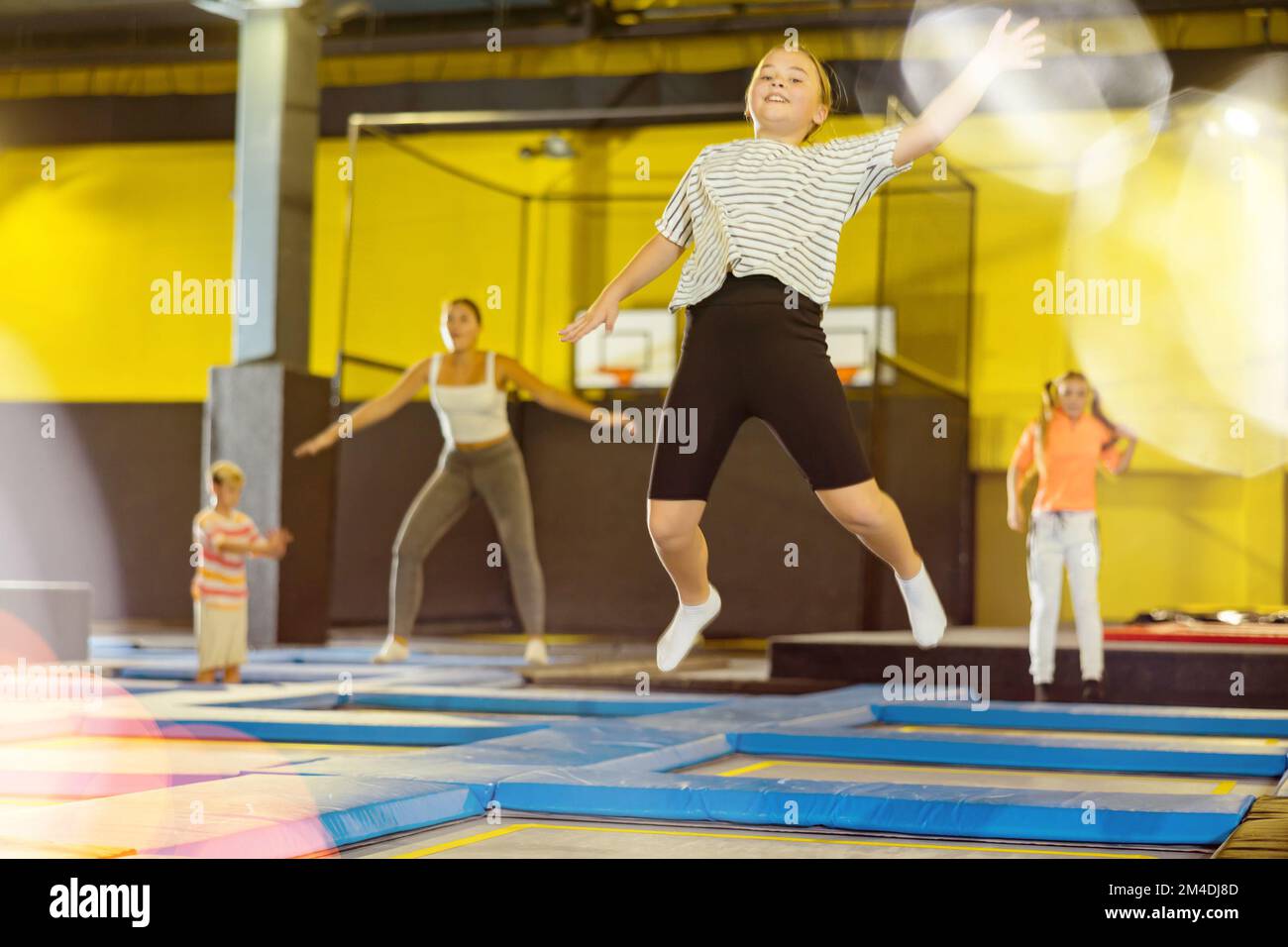 Girl jumping on trampoline park in sport center Stock Photo - Alamy