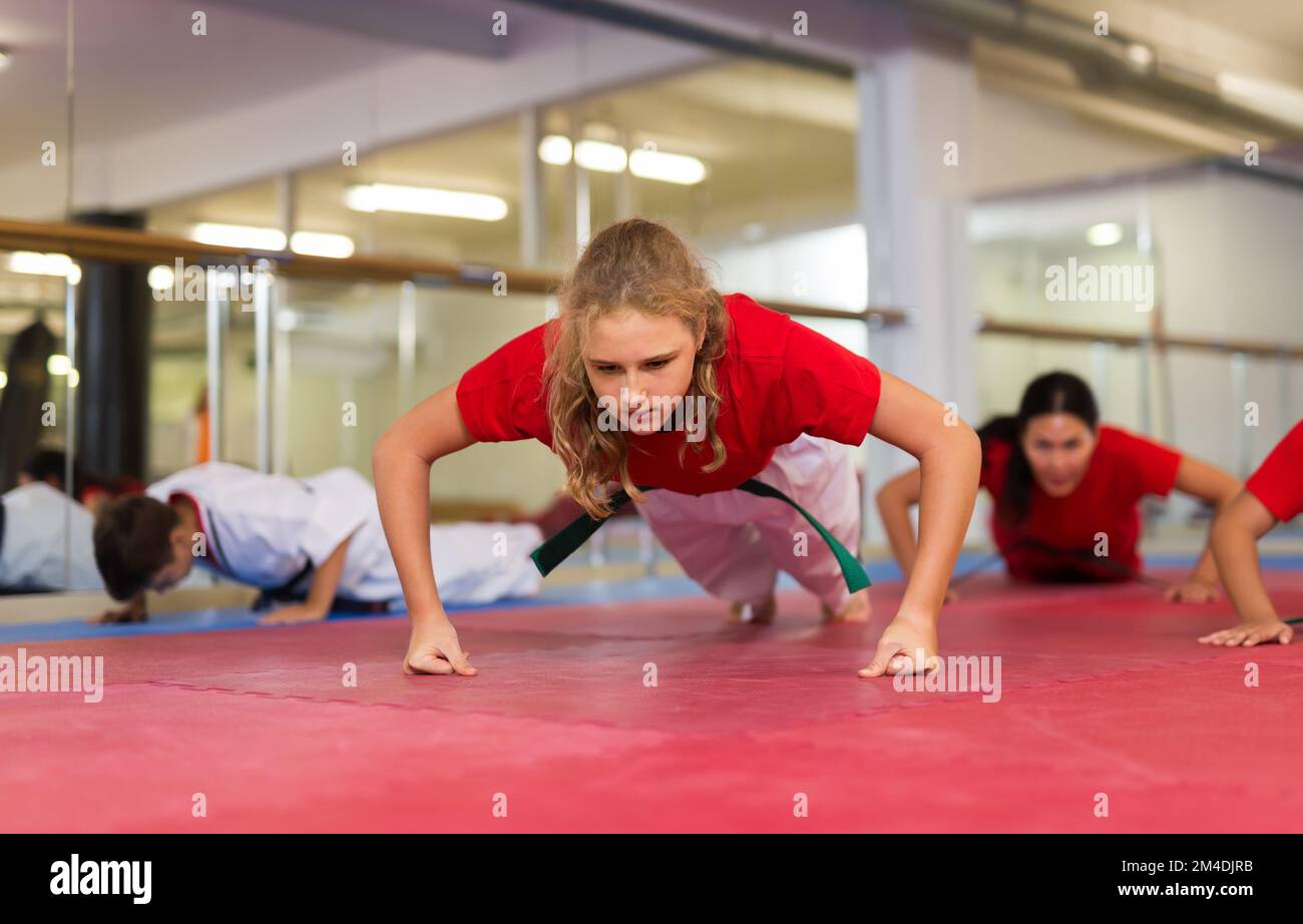 Preteen girl doing push-ups Stock Photo - Alamy