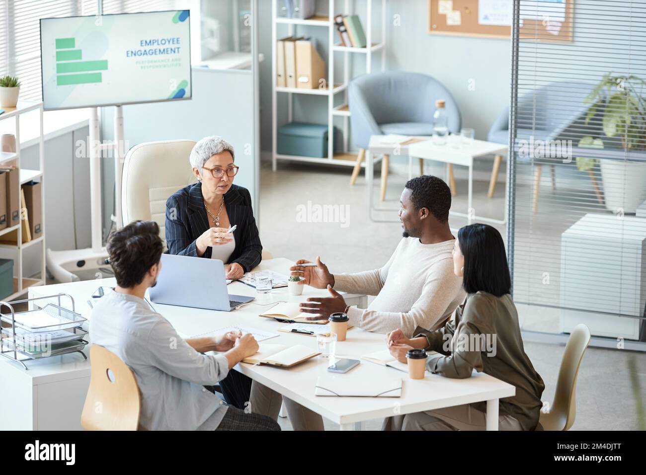 High angle portrait of senior female boss leading business meeting in ...