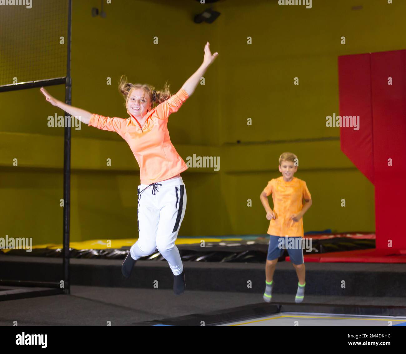 Full length of happy teenage girl in sportswear having fun while ...