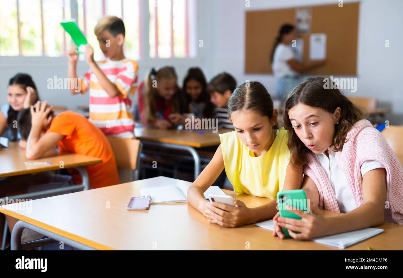 Schoolchildren use mobile phones at the lesson in classroom Stock Photo ...
