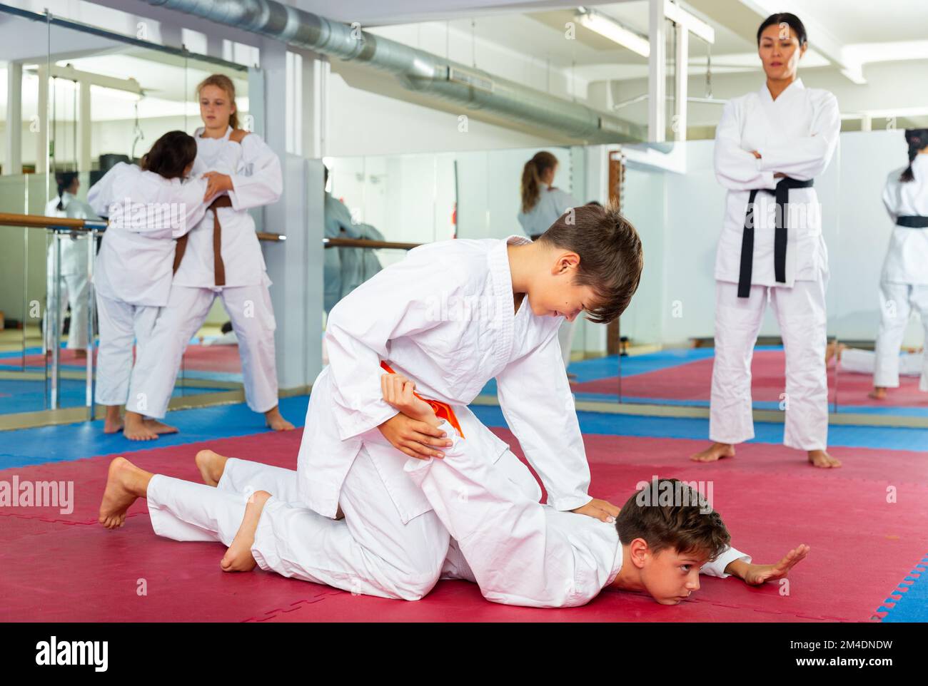 Boys performing arm lock movement during karate training Stock Photo ...