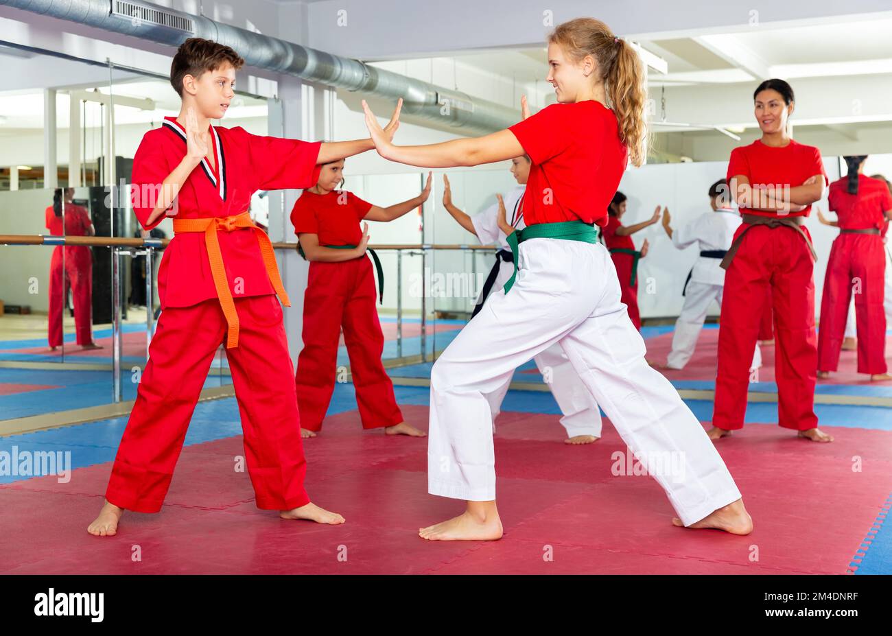 Group of children doing karate kicks during karate class Stock Photo ...