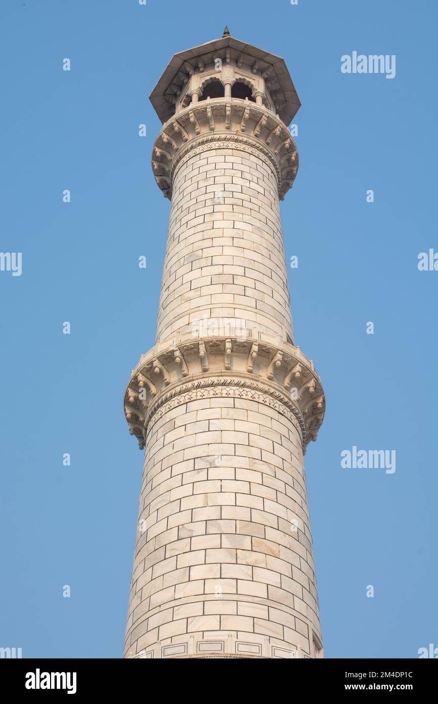 A vertical shot of the Taj Mahal tower against the blue sky Stock Photo ...