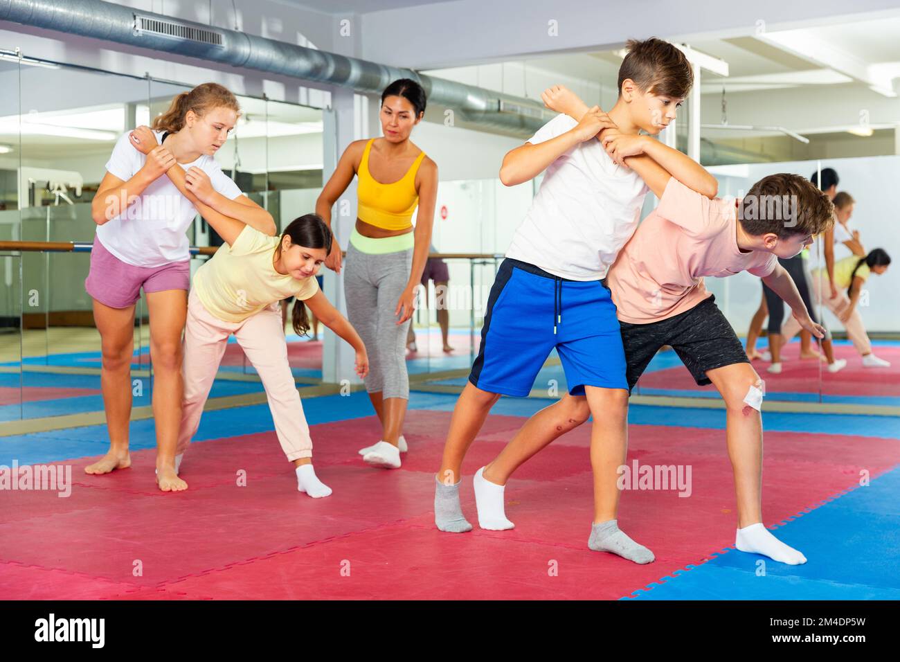 Kids in pair exercising self-defense movements Stock Photo - Alamy