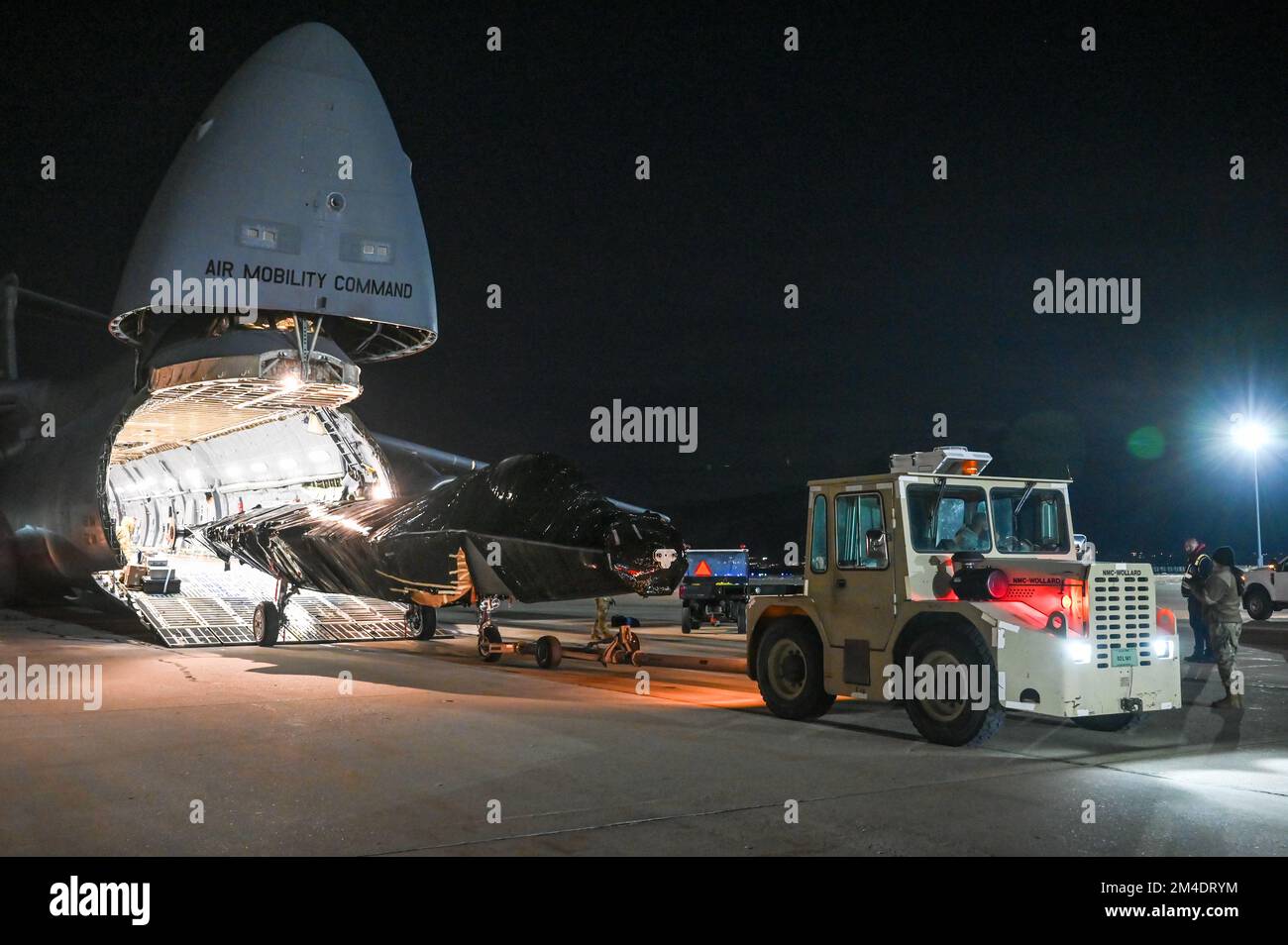 The fuselage of an F-22 Raptor emerges from inside a C-5M Galaxy ...