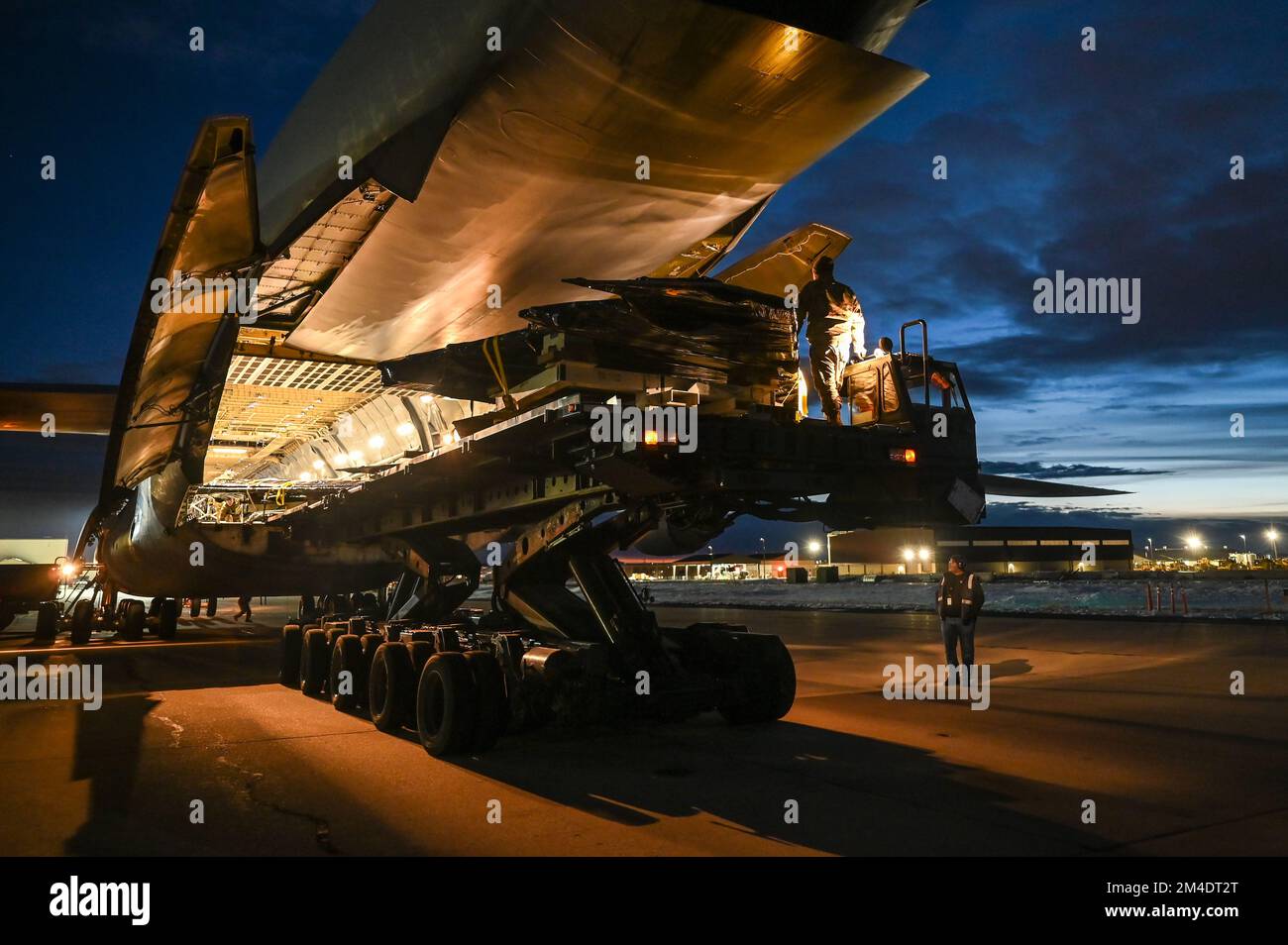 The wings of an F-22 Raptor emerge from inside a C-5M Galaxy assigned ...