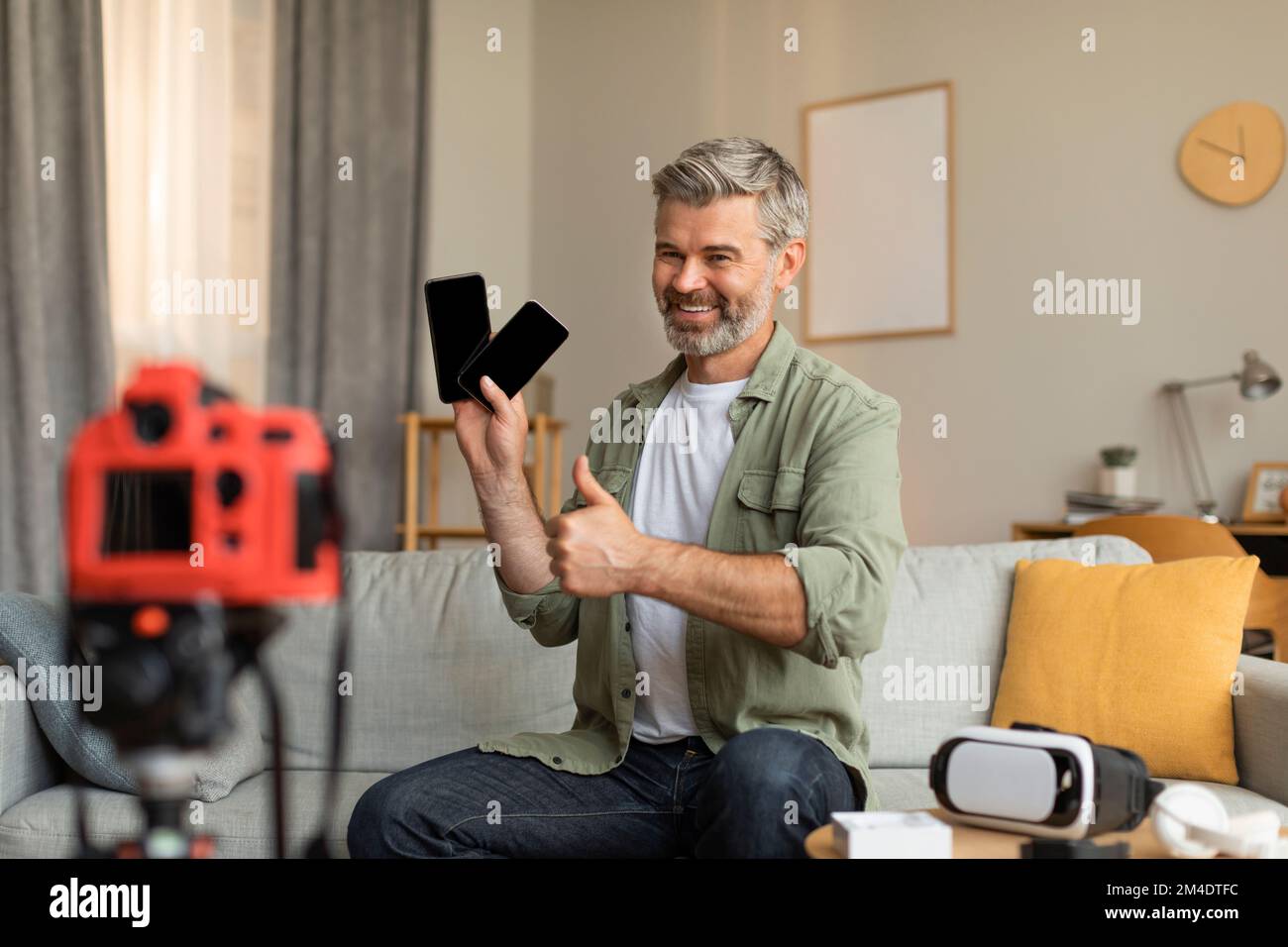 Happy elderly caucasian man shooting video blog about technology ...