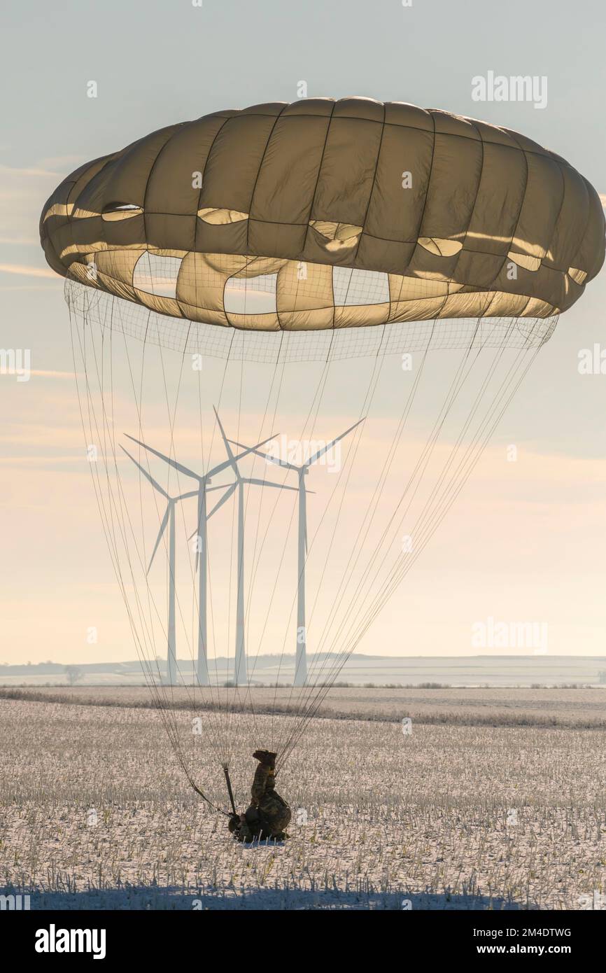 A paratrooper landing at the Alzey Drop Zone after a jump off a C-130 ...