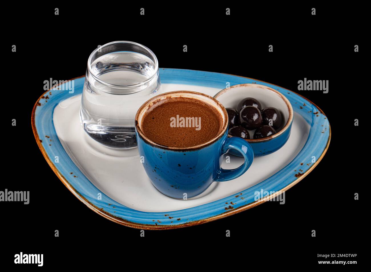 Turkish coffee in a blue cup, chocolate on a porcelain serving tray ...