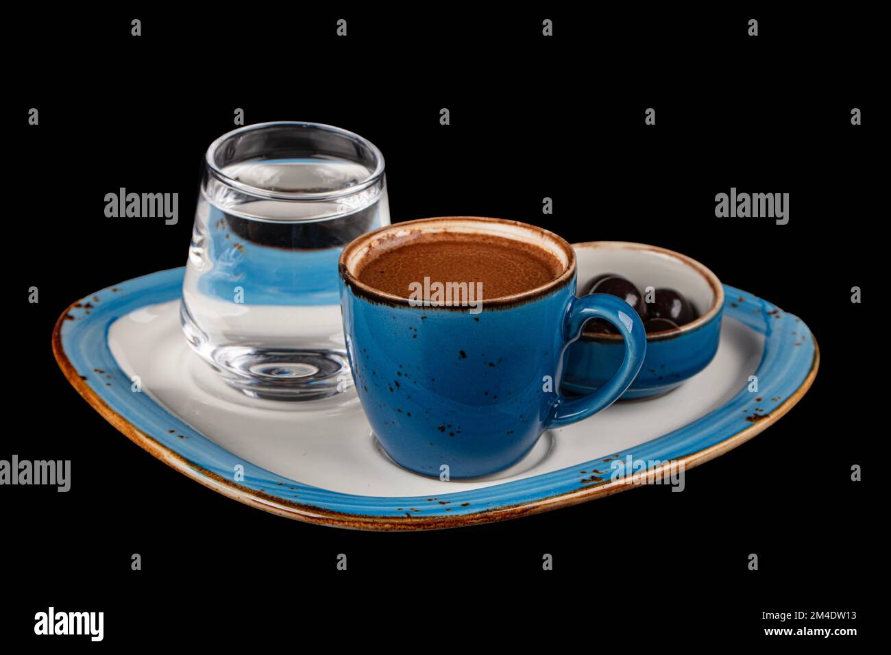 Turkish coffee in a blue cup, chocolate on a porcelain serving tray ...