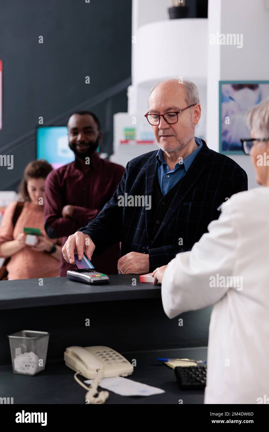 Senior client paying supplements hi-res stock photography and images ...