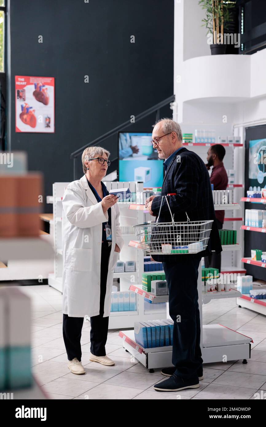 Drugstore worker helping client with pharmaceutical treatment ...