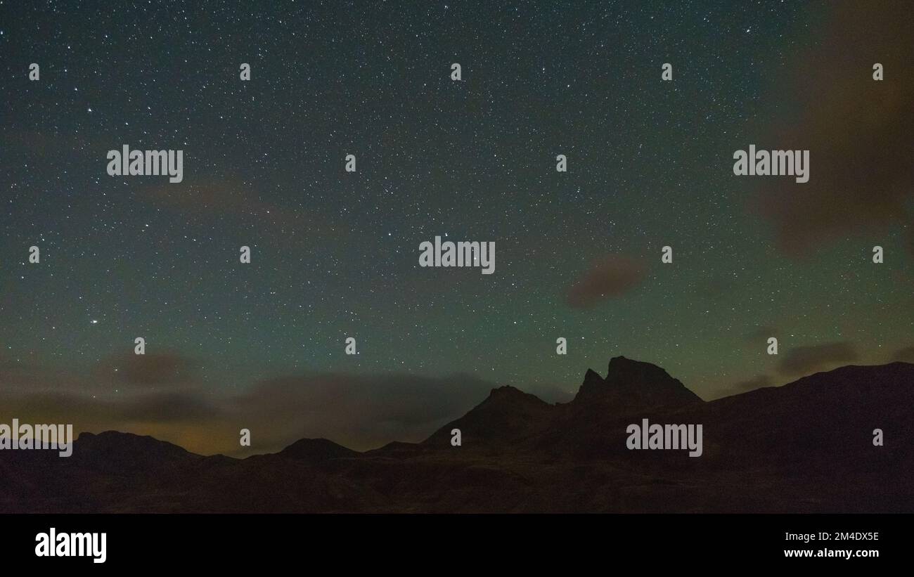Night sky with stars and Big Dipper constellation over peaks of ...