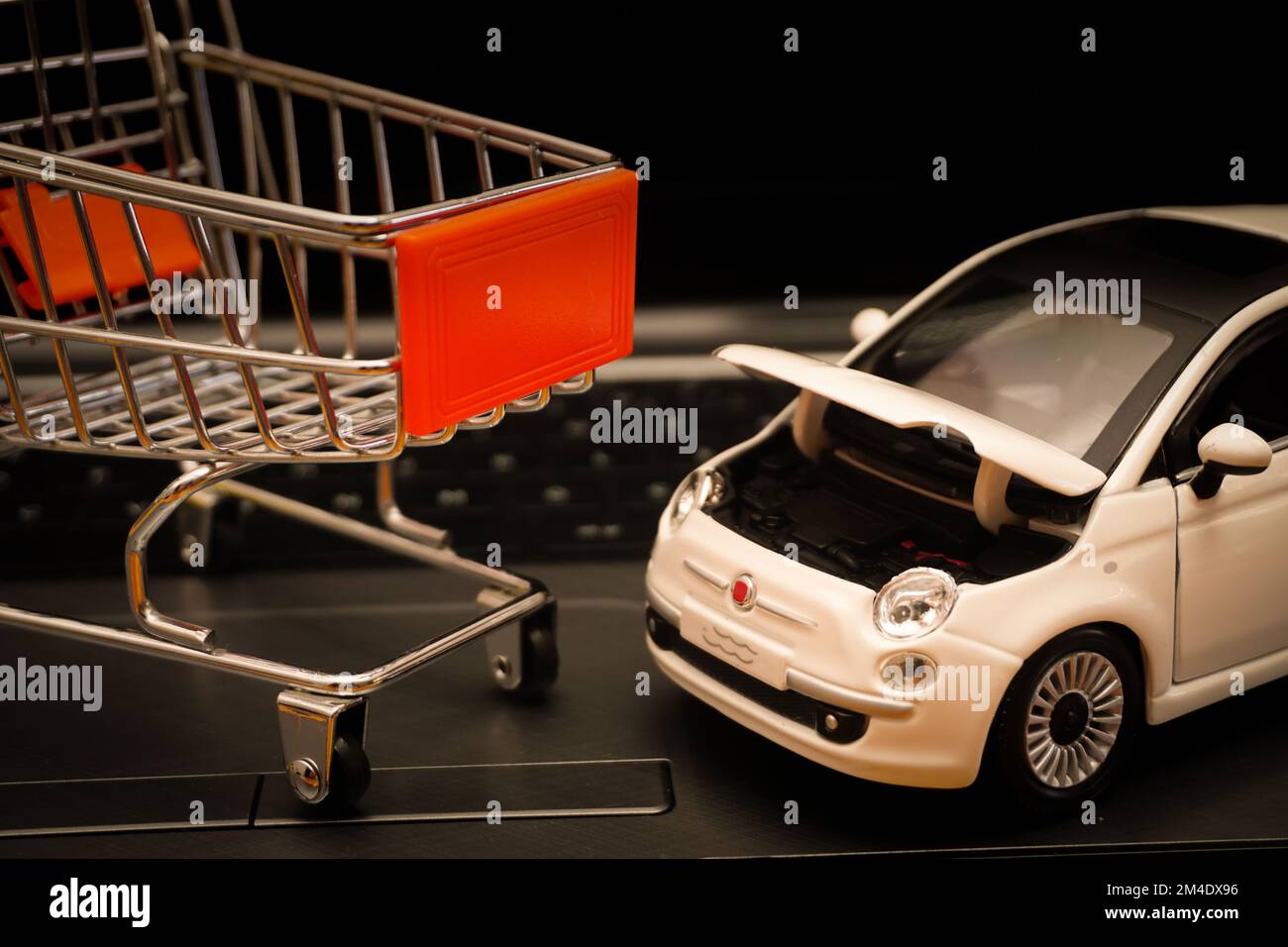 A miniature shopping cart and a car Stock Photo - Alamy