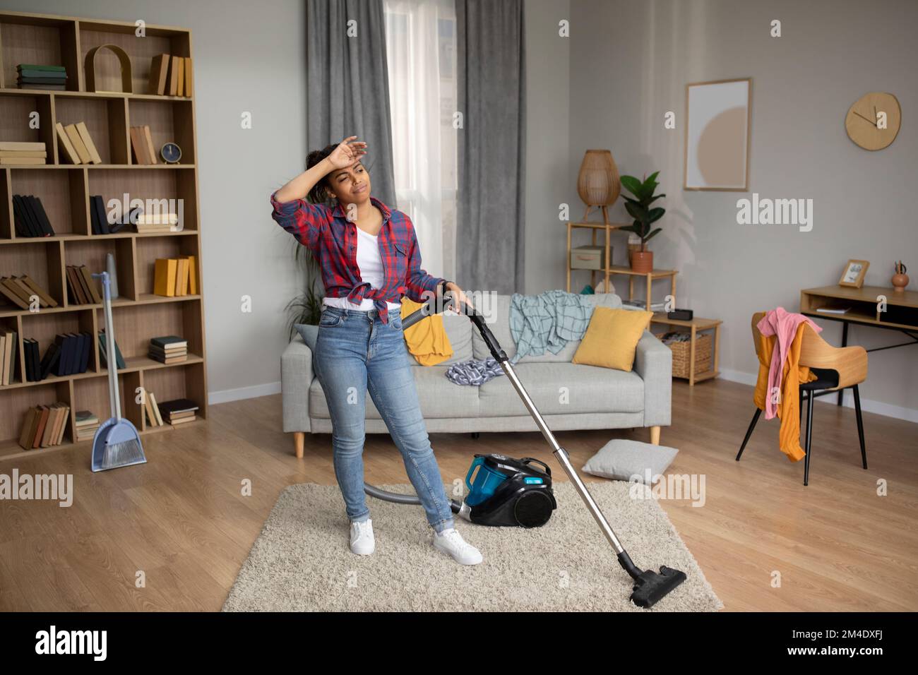 Tired sad millennial african american housewife wipes forehead and with ...