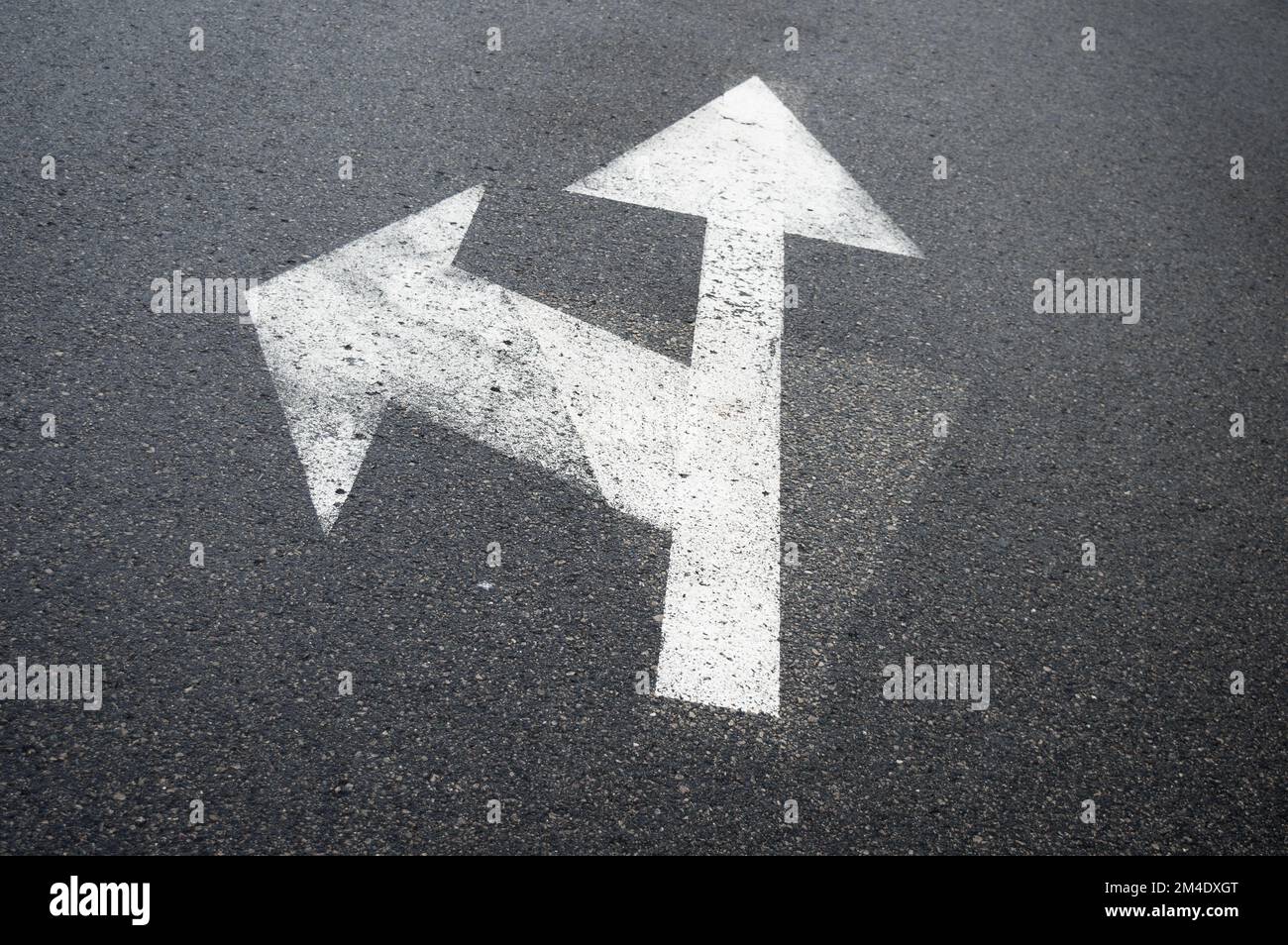 Arrow on asphalt showing direction. Grey background with a direction ...