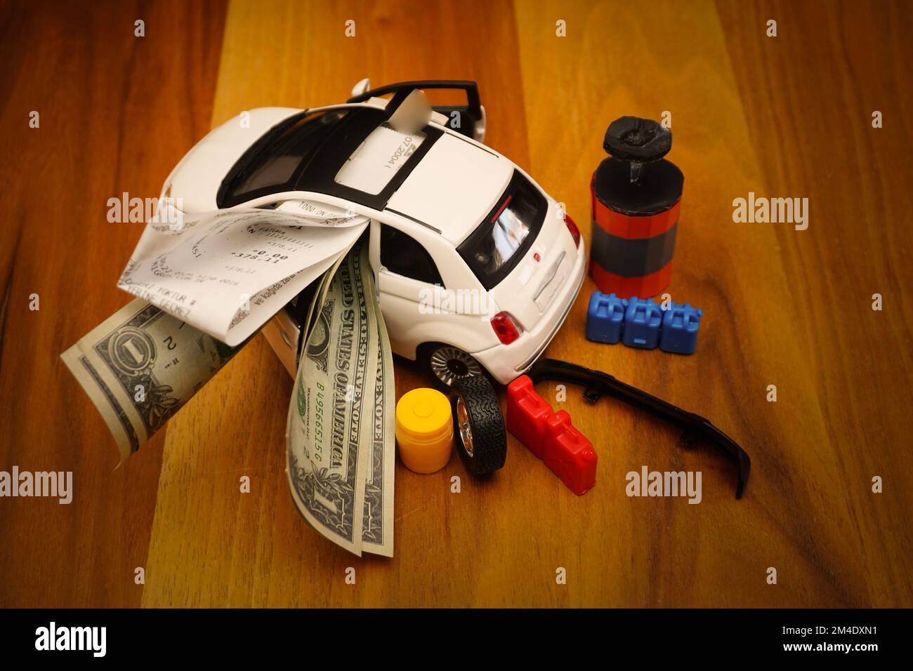 A miniature car filled with banknotes representing car expenses Stock ...