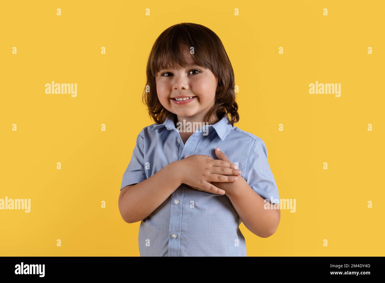 Sincere gratitude. Cute happy little boy feeling thankful and proud ...