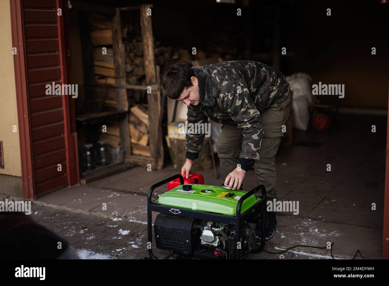 Man wear in military jacket with gasoline portable mobile backup ...