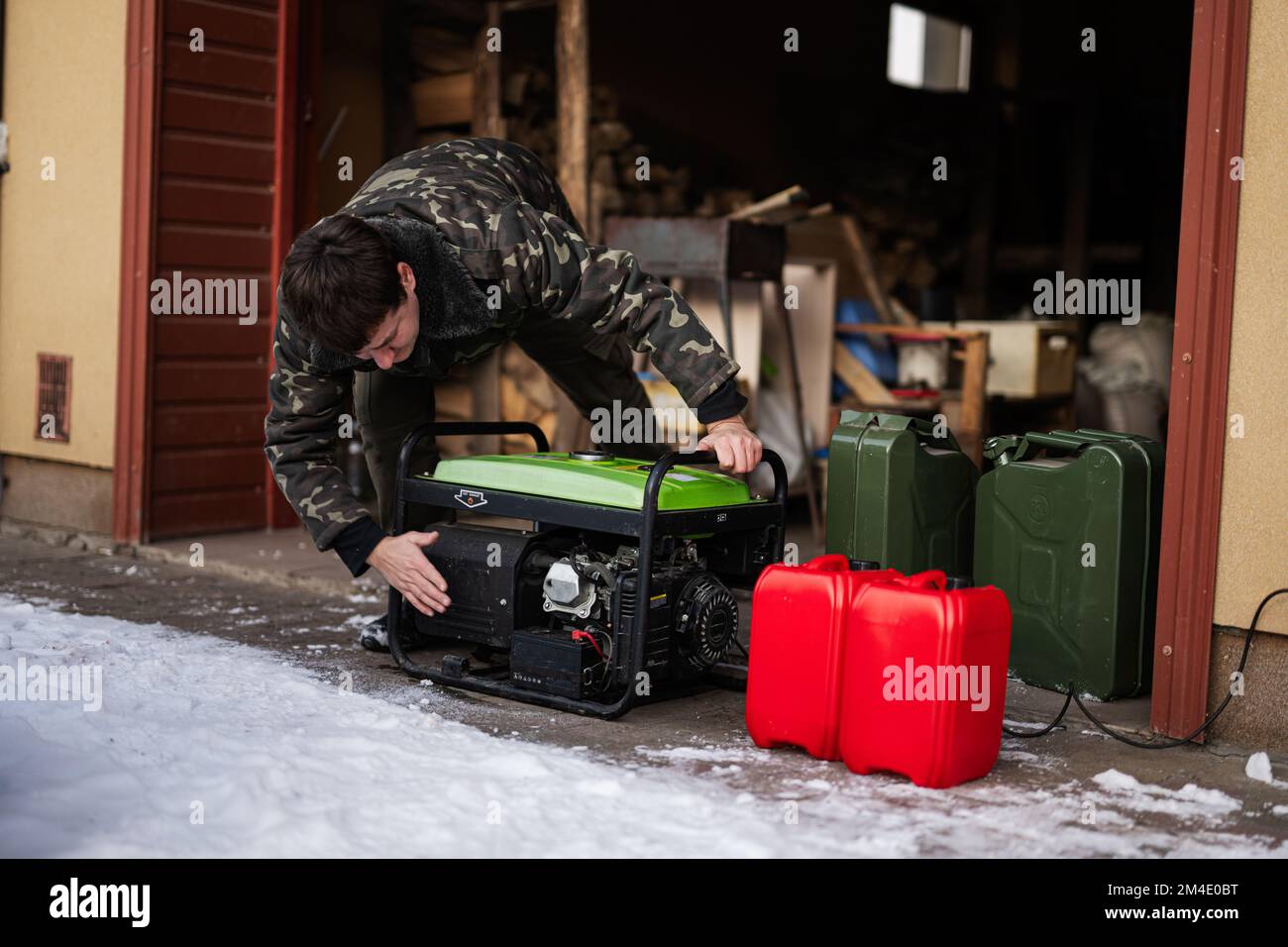 Man wear in military jacket with gasoline portable mobile backup ...