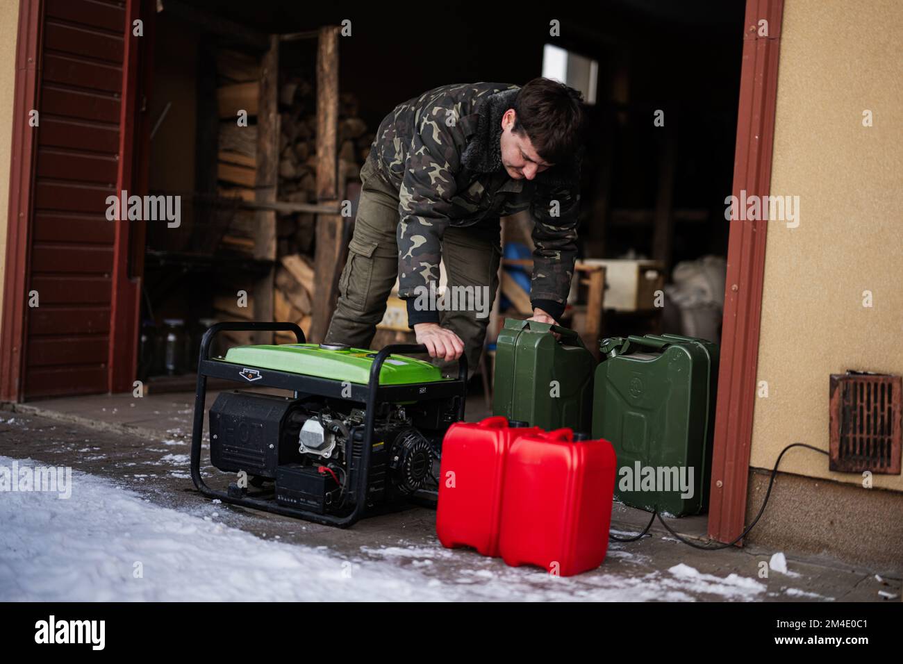Man wear in military jacket with gasoline portable mobile backup ...