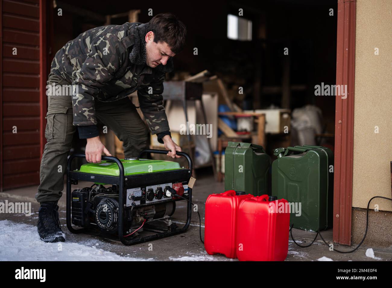 Man wear in military jacket with gasoline portable mobile backup ...