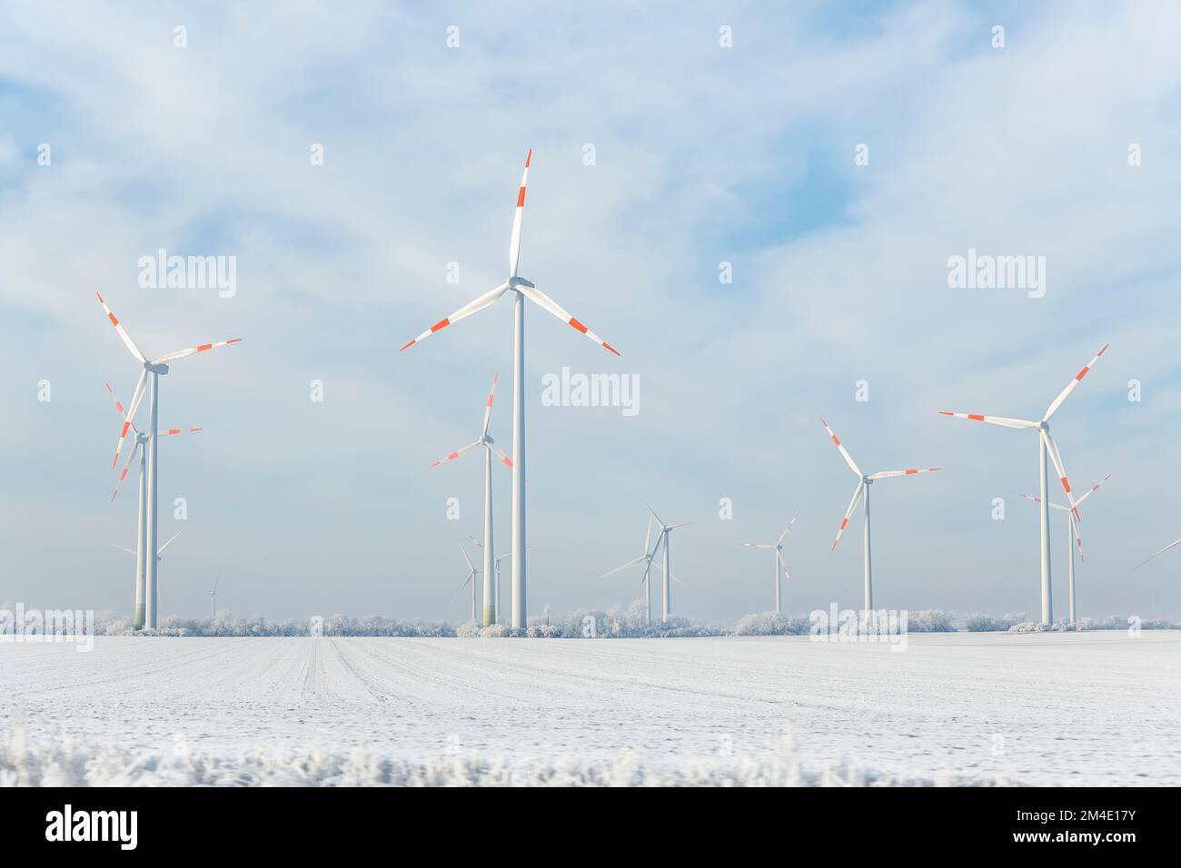 Scenic landscape view of white snowy frosty field and big modern wind ...