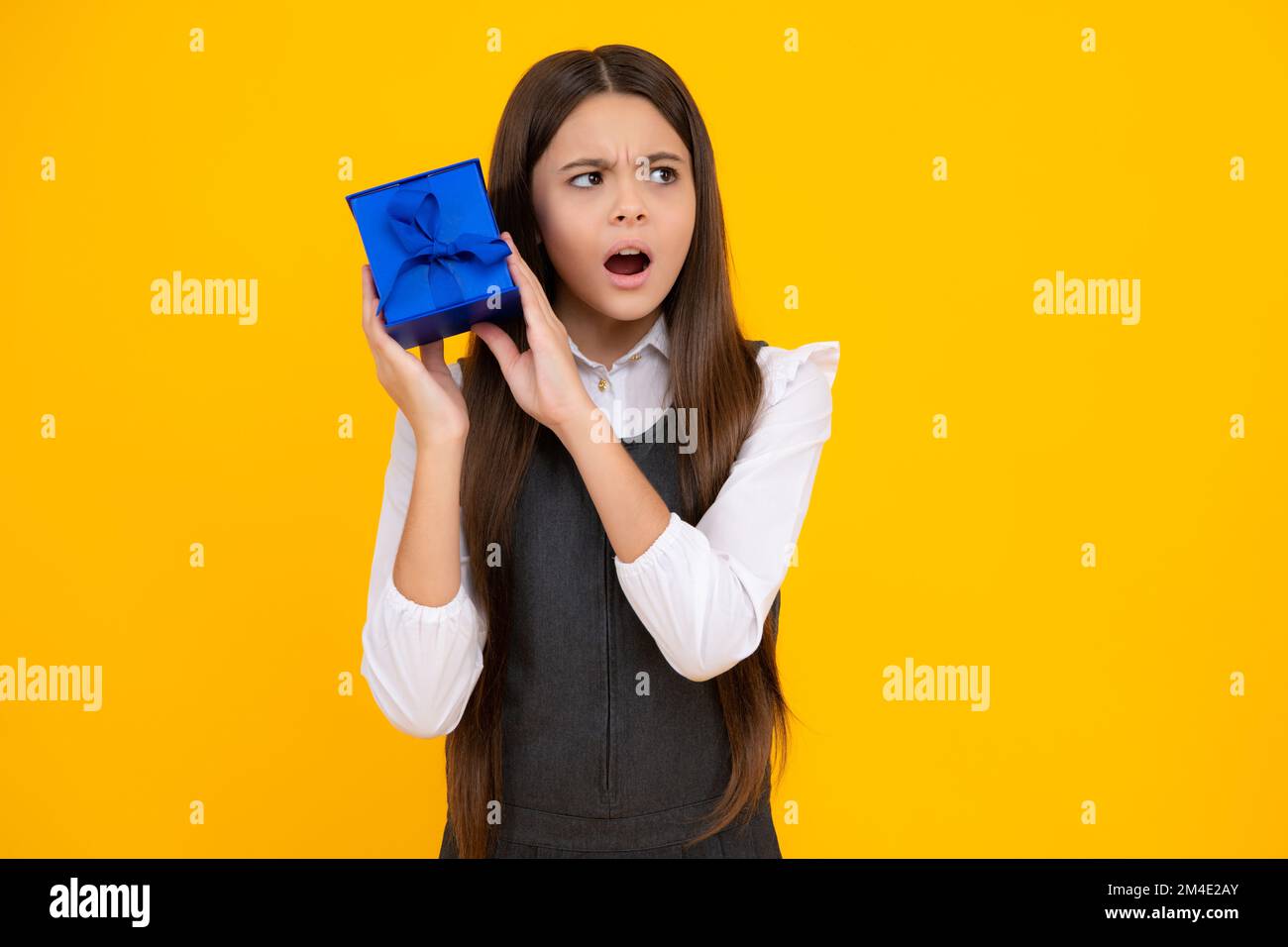 Shocked surprised teenager girl. Teenager kid with present box. Teen ...