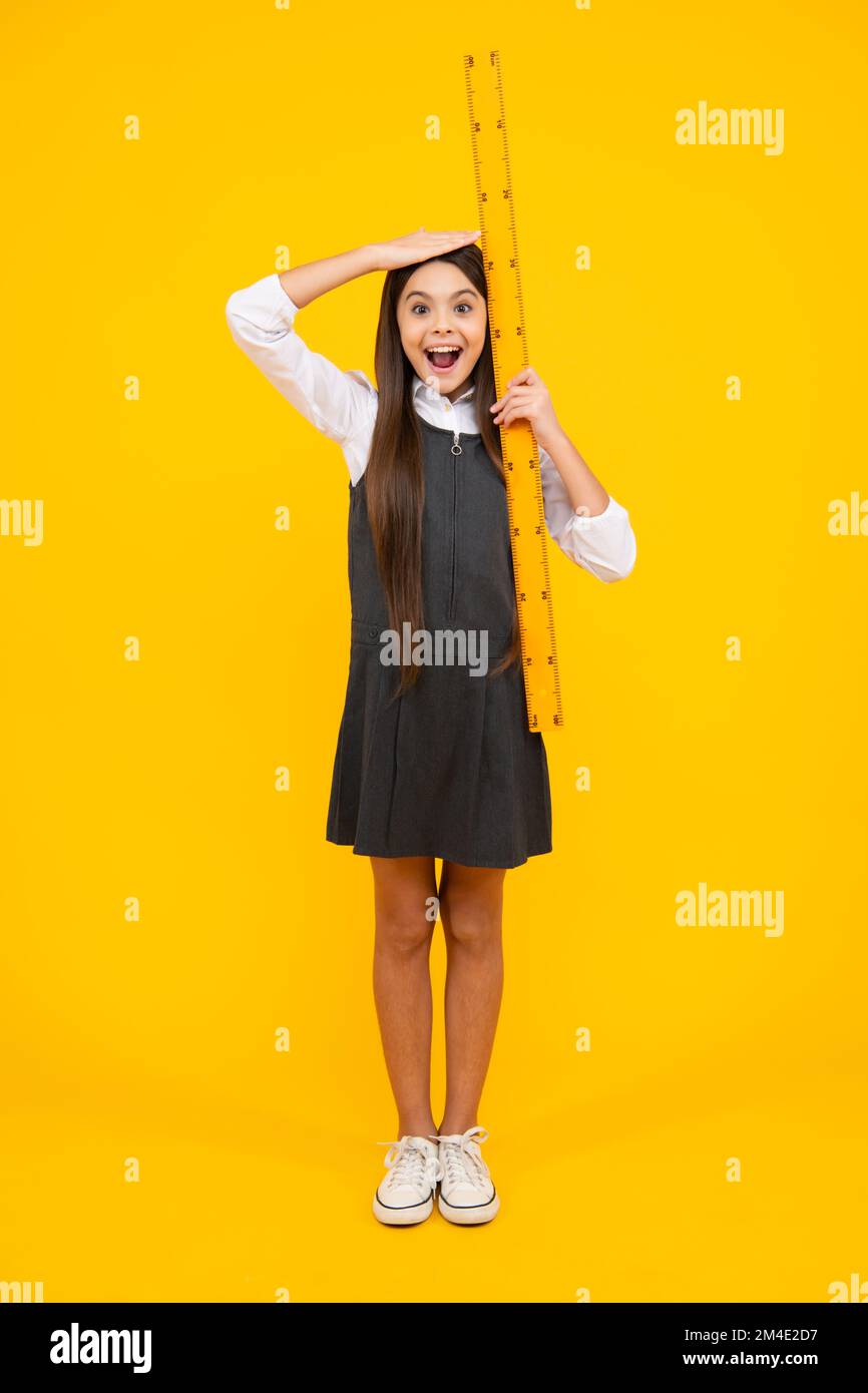 Kid height measure, growth measurement. Schoolgirl holding measure for ...