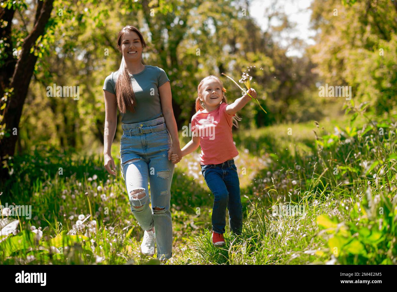 Woman walking daughter to school hi-res stock photography and images ...