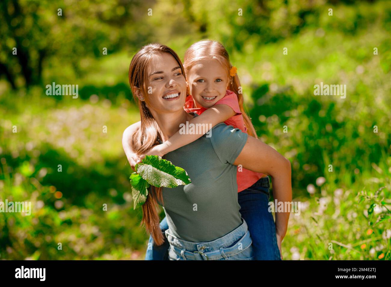 Mom carrying her kid on her back and both feeling amazing Stock Photo ...