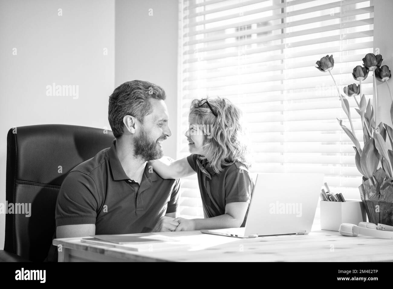 back to school. loving daddy and son in glasses use computer at home ...