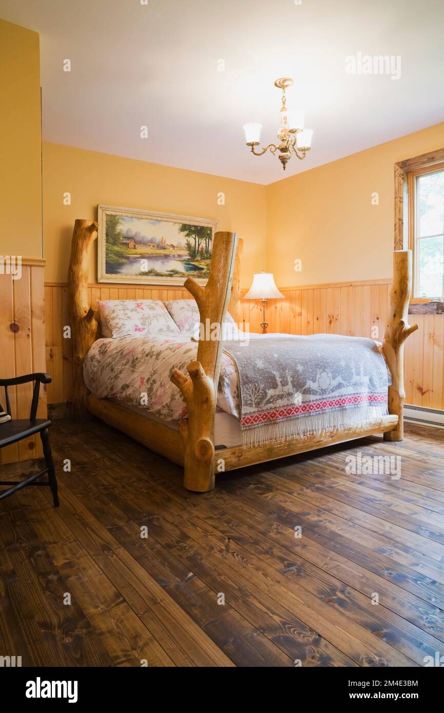 Rustic four poster bed in upstairs guest bedroom with nuanced brown ...