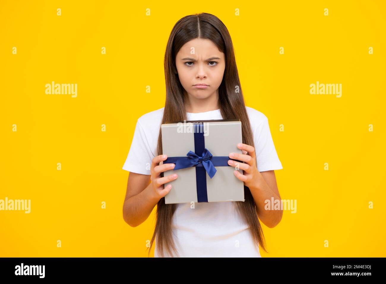 Child with gift present box on isolated studio background. Gifting for ...