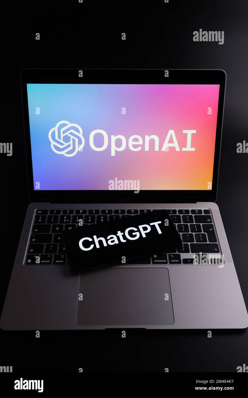 ChatGPT logo seen on smartphone and laptop display with blurred OpenAI company logotype. AI ...