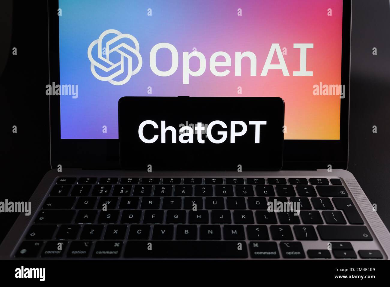 ChatGPT logo seen on smartphone and laptop display with blurred OpenAI company logotype. AI ...