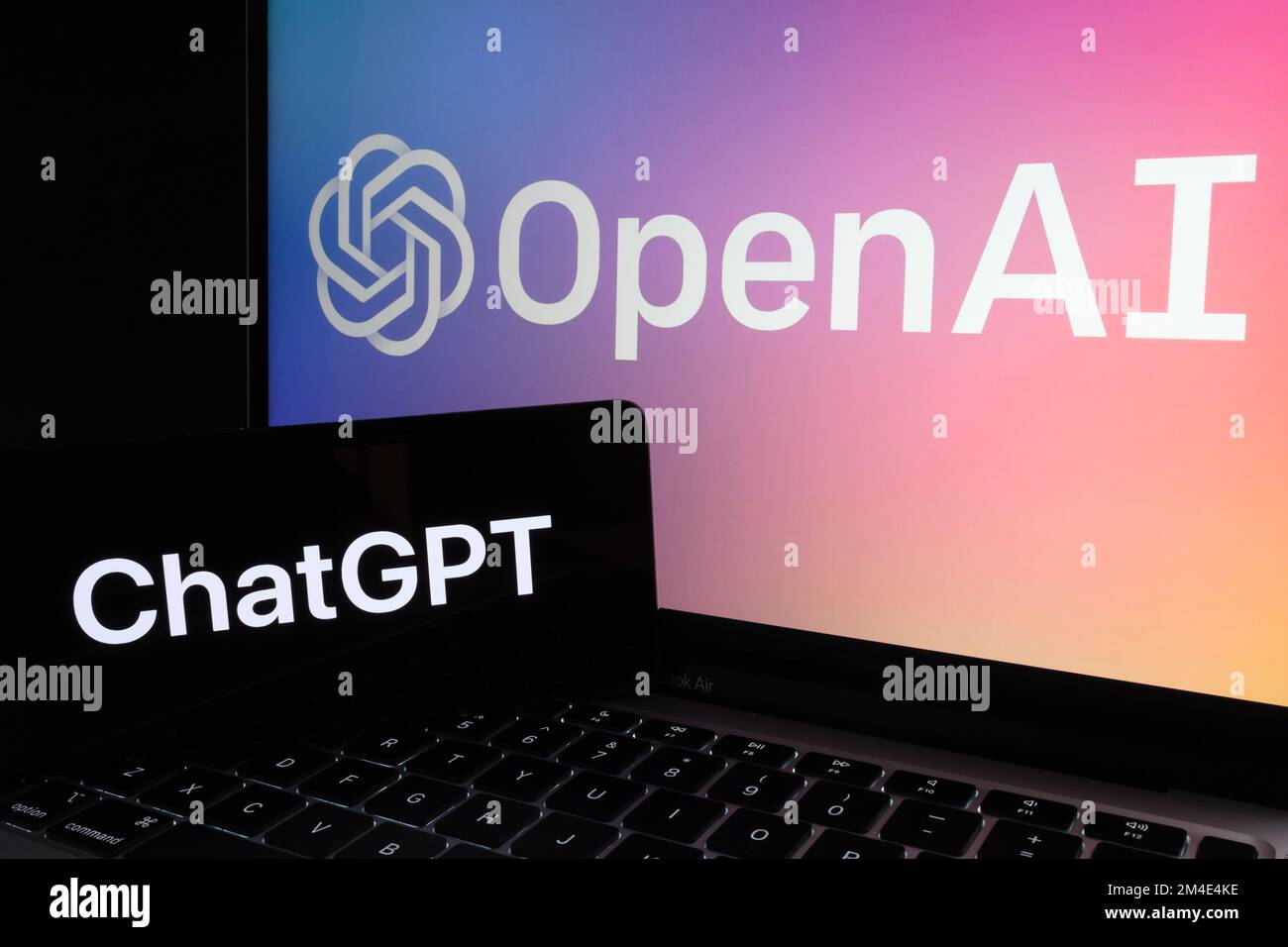 ChatGPT logo seen on smartphone and laptop display with blurred OpenAI company logotype. AI ...