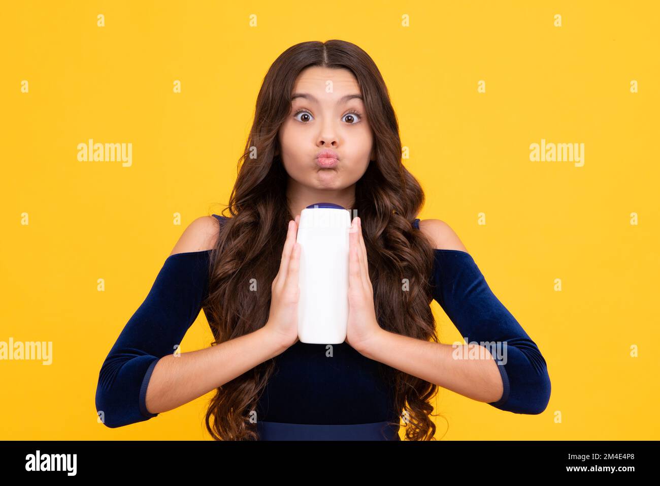 Funny face. Teenage girl with shampoos conditioners or shower gel. Kids ...