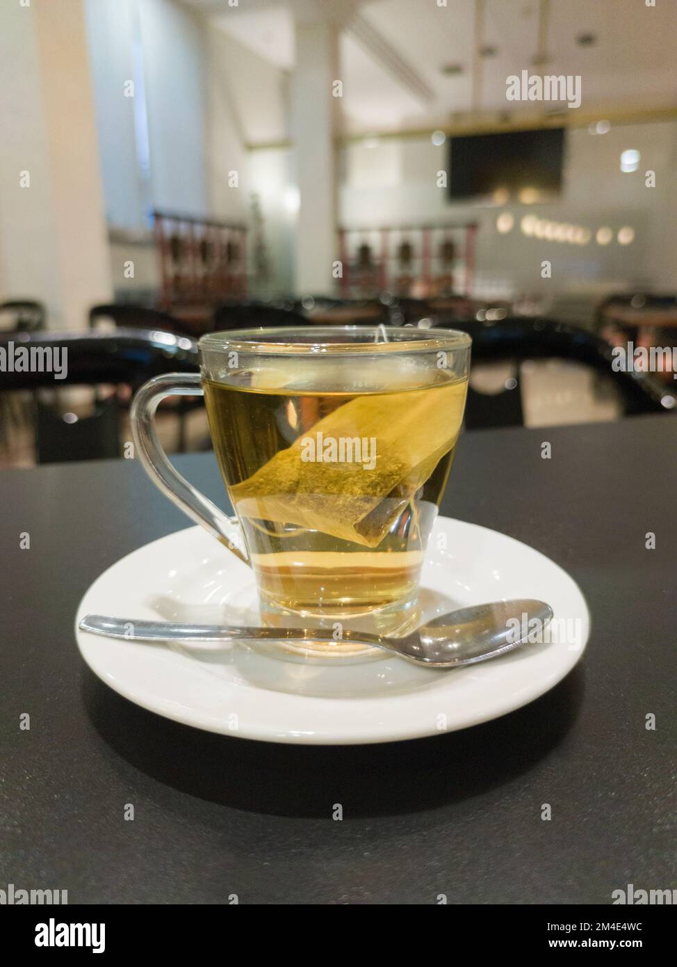 Hot chamomile tea glass cup over restaurant table. Selective focus ...