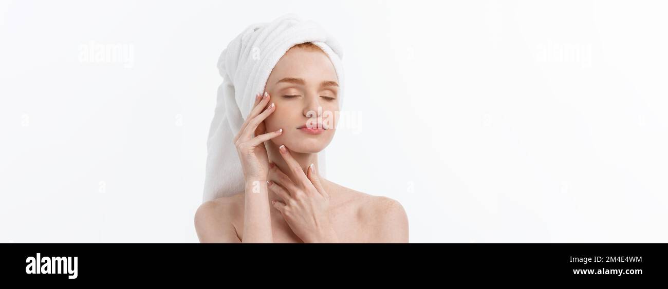 beautiful model applying cosmetic cream treatment on her face on white ...