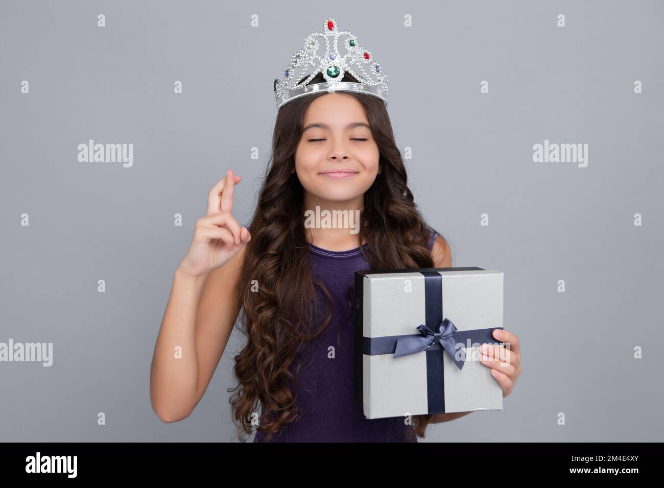 Child princess in crown dreaming. Teenager kid with present box. Teen ...