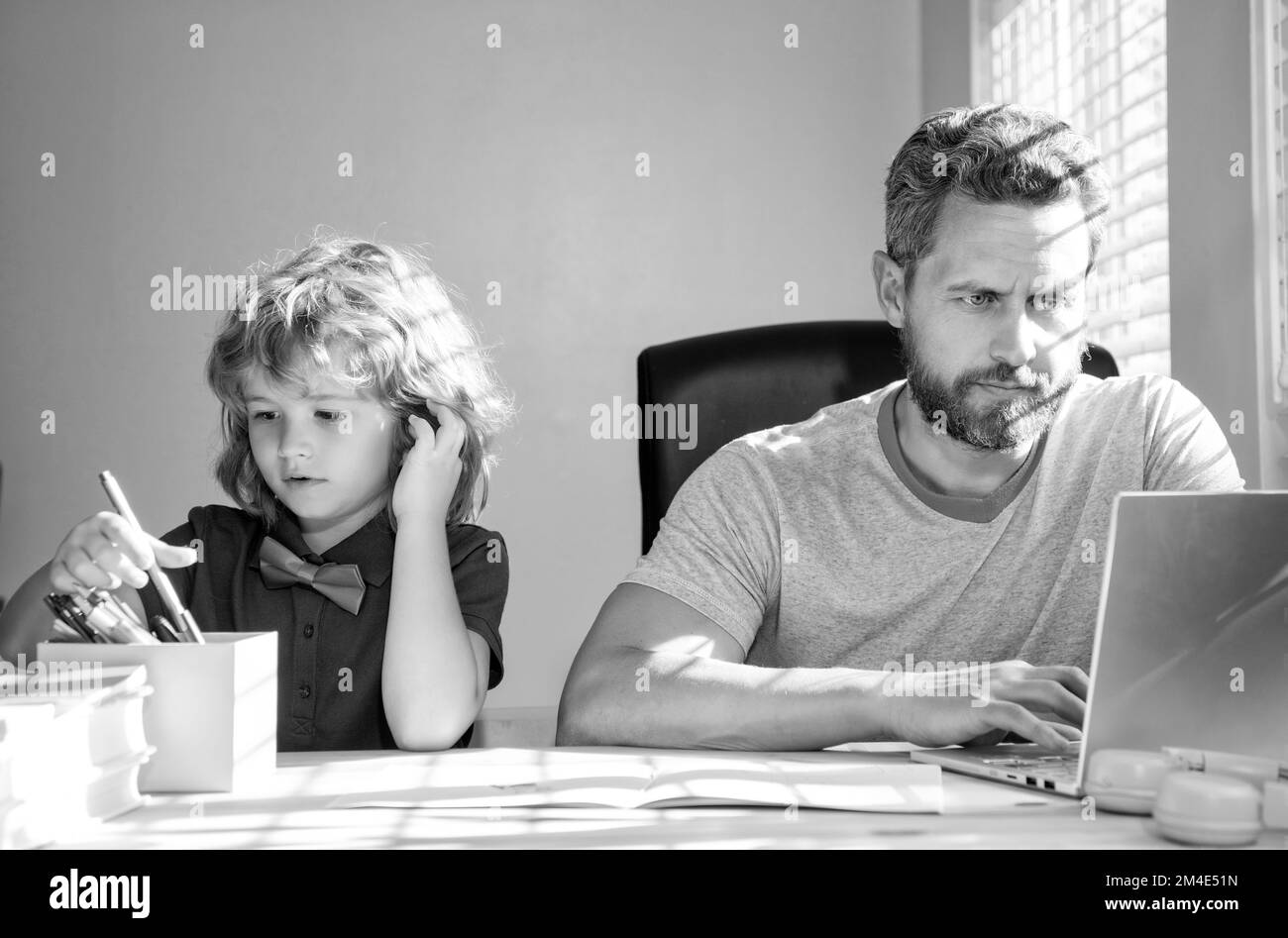 mature man teacher or dad helping kid son with school homework on ...