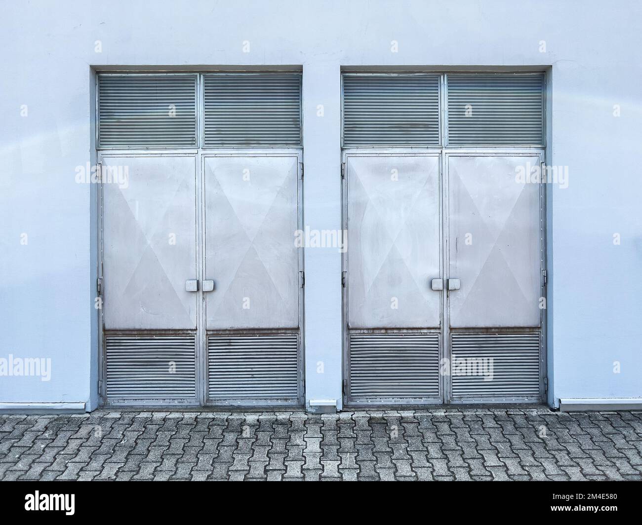 Two iron doors on a building Stock Photo - Alamy