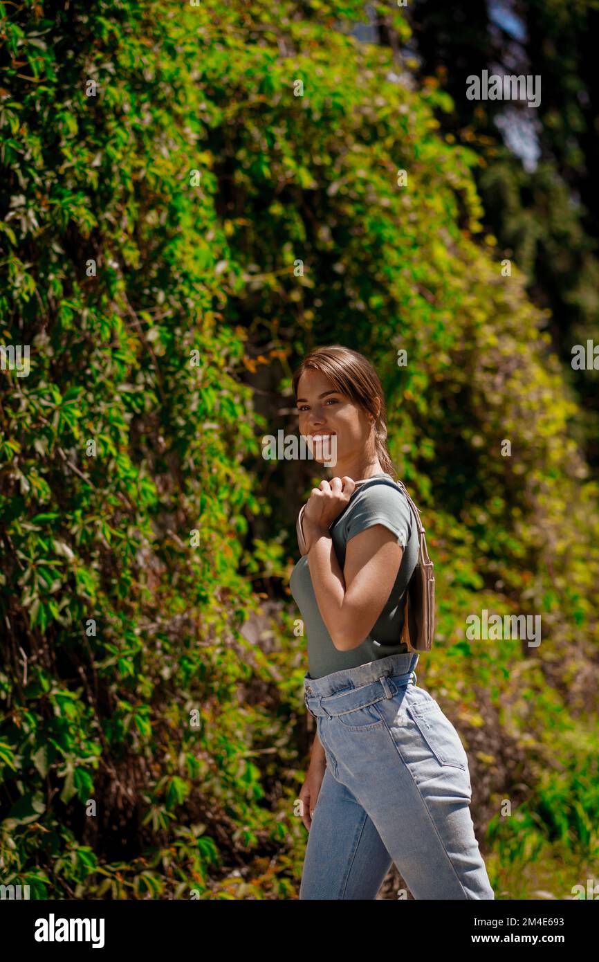 Young woman on the greenery background Stock Photo - Alamy