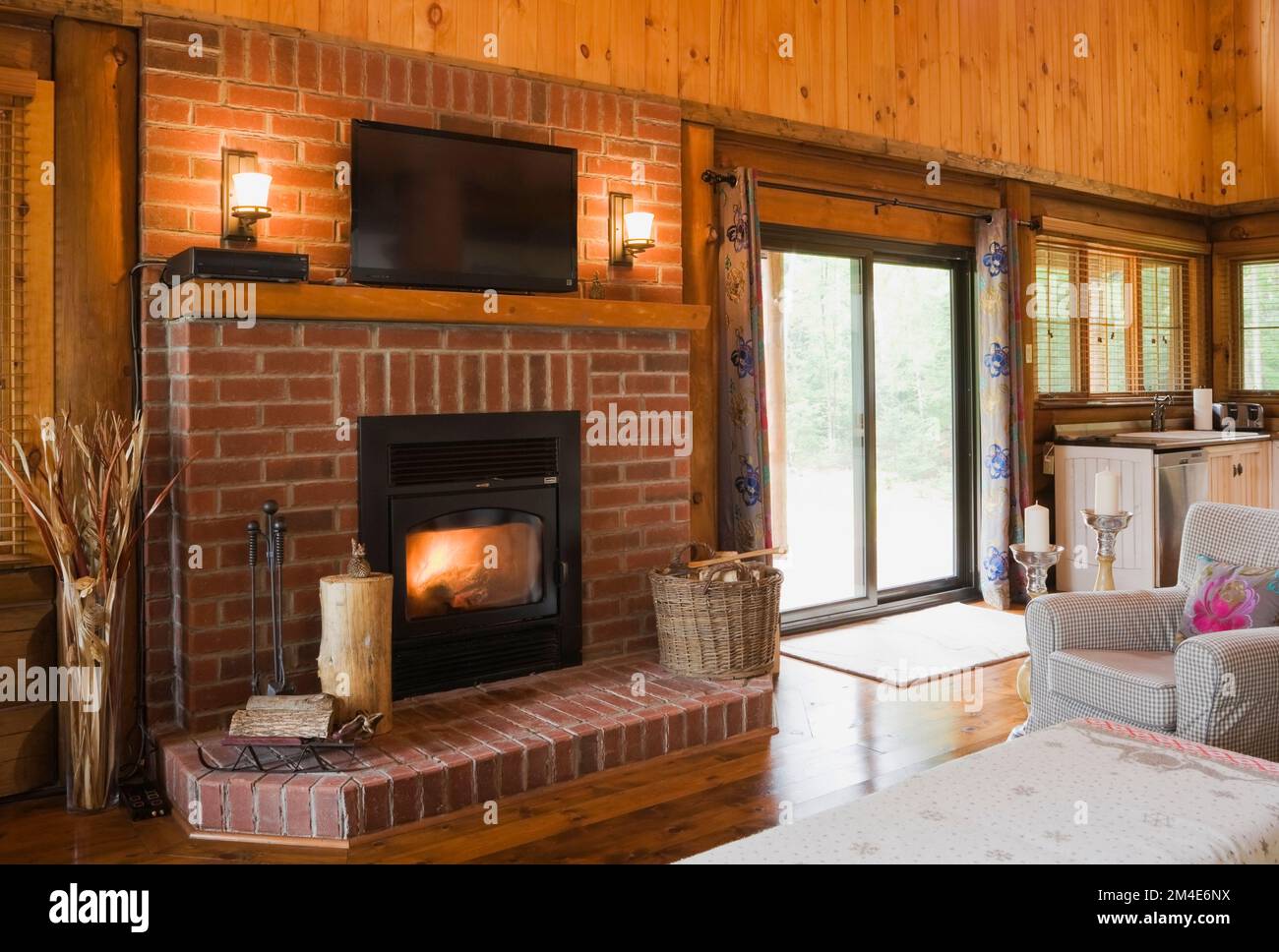 Red brick wood burning fireplace in living room inside log home Stock ...
