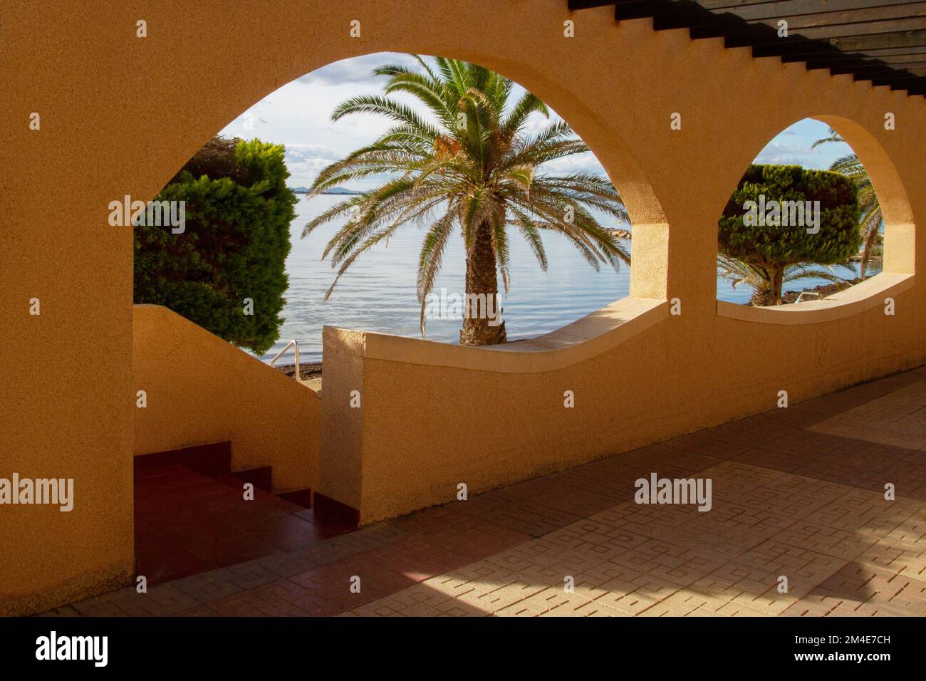 semicircular arch with round windows overlooking the sea Stock Photo ...